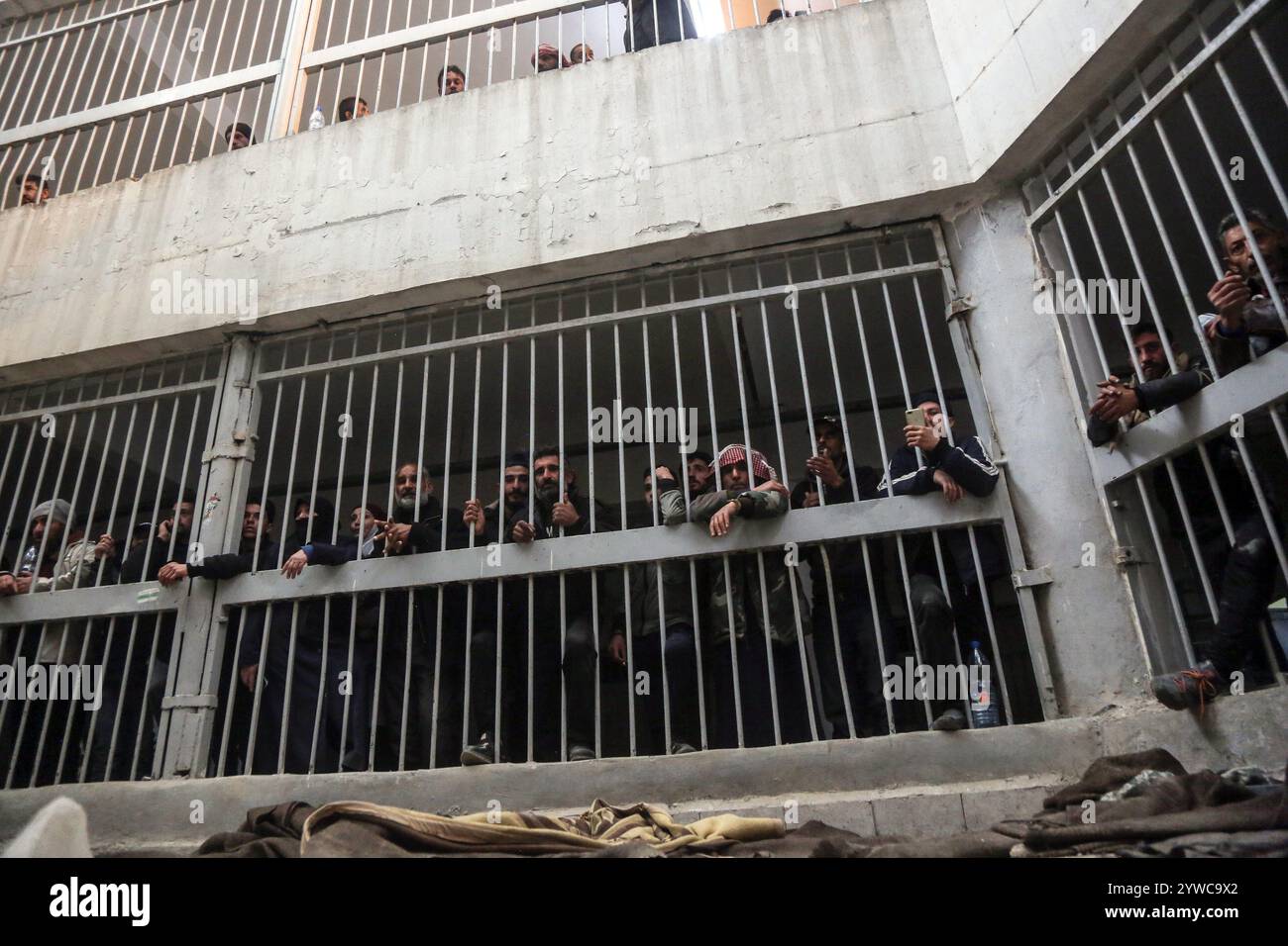 People gather at the Saydnaya prison in Damascus looking for loved ones ...