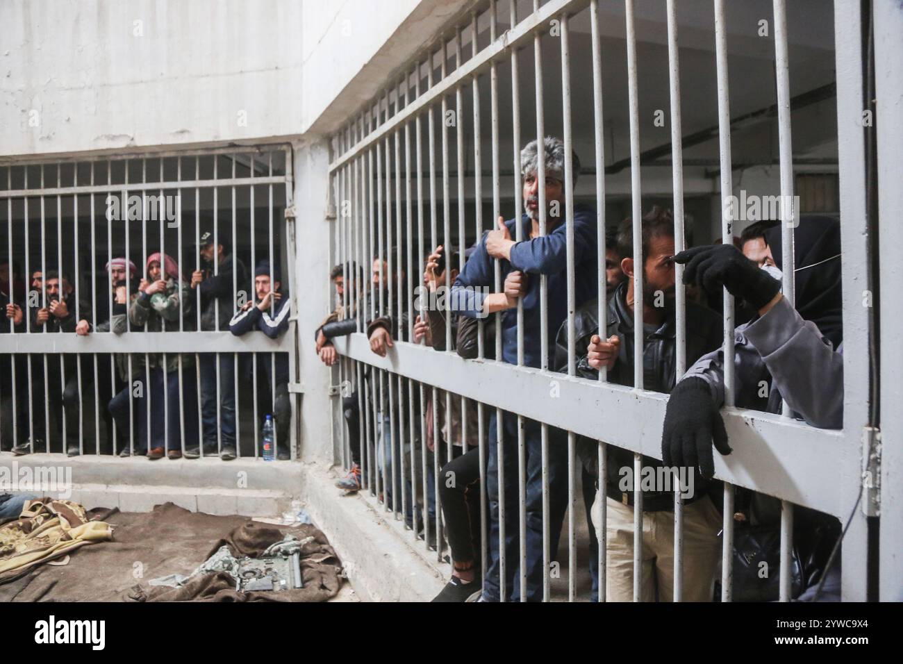 People gather at the Saydnaya prison in Damascus looking for loved ones ...