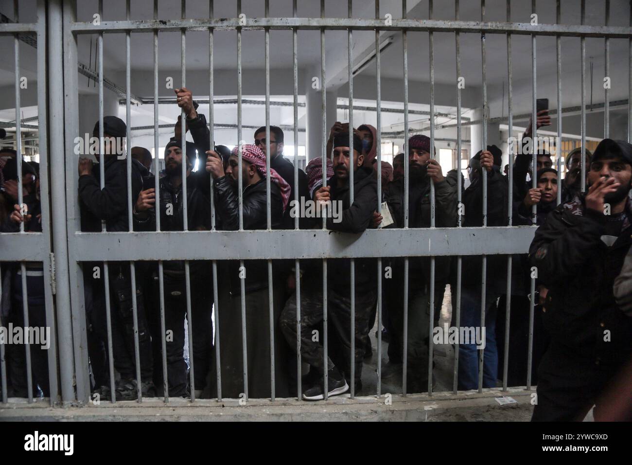 People gather at the Saydnaya prison in Damascus looking for loved ones ...