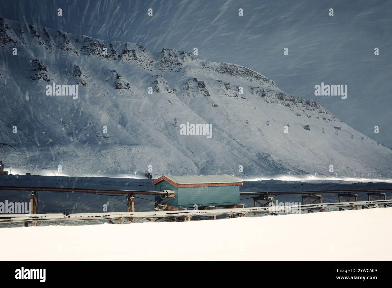 Pipes running through wooden shed in snow in Longyearbyen, Svalbard ...
