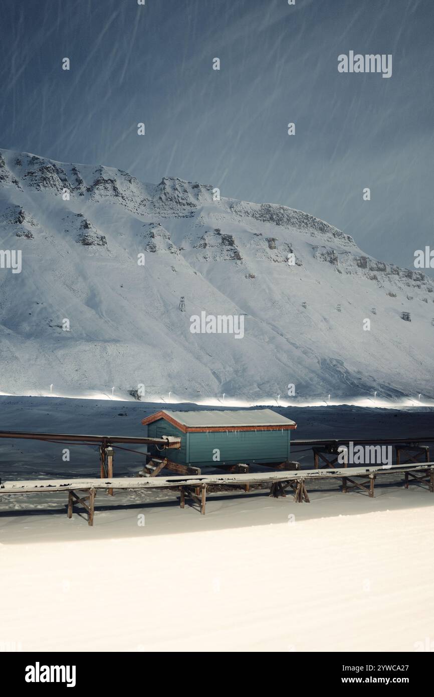 Pipes running through shed in the snow in Longyearbyen, Svalbard ...