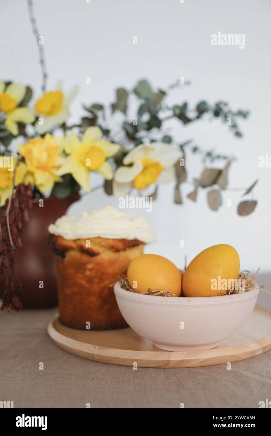 Easter sponge cake with buttercream icing on a table with fresh eggs ...