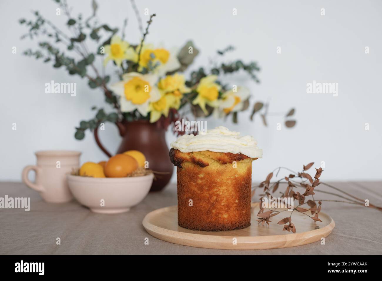 Easter sponge cake with buttercream icing on a table with fresh eggs ...