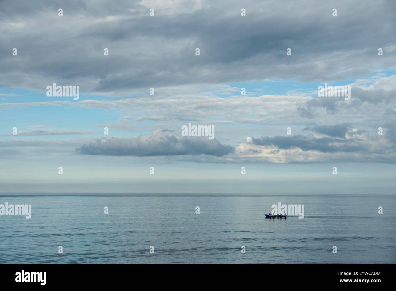 Distant view of five people in a rowing boat at sea, St Andrews, Fife ...