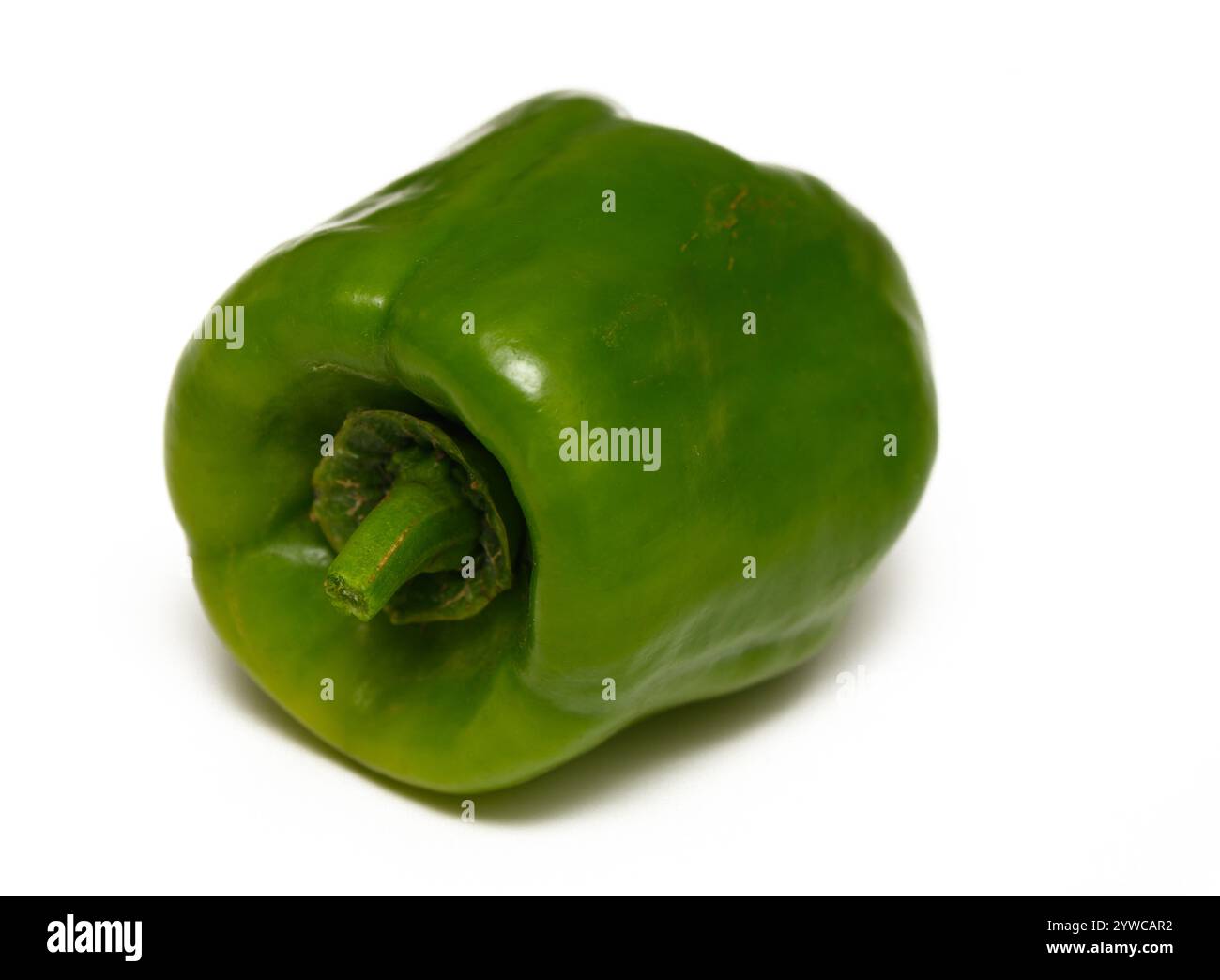 A vivid green bell pepper showcases its glossy skin, perfect for adding ...