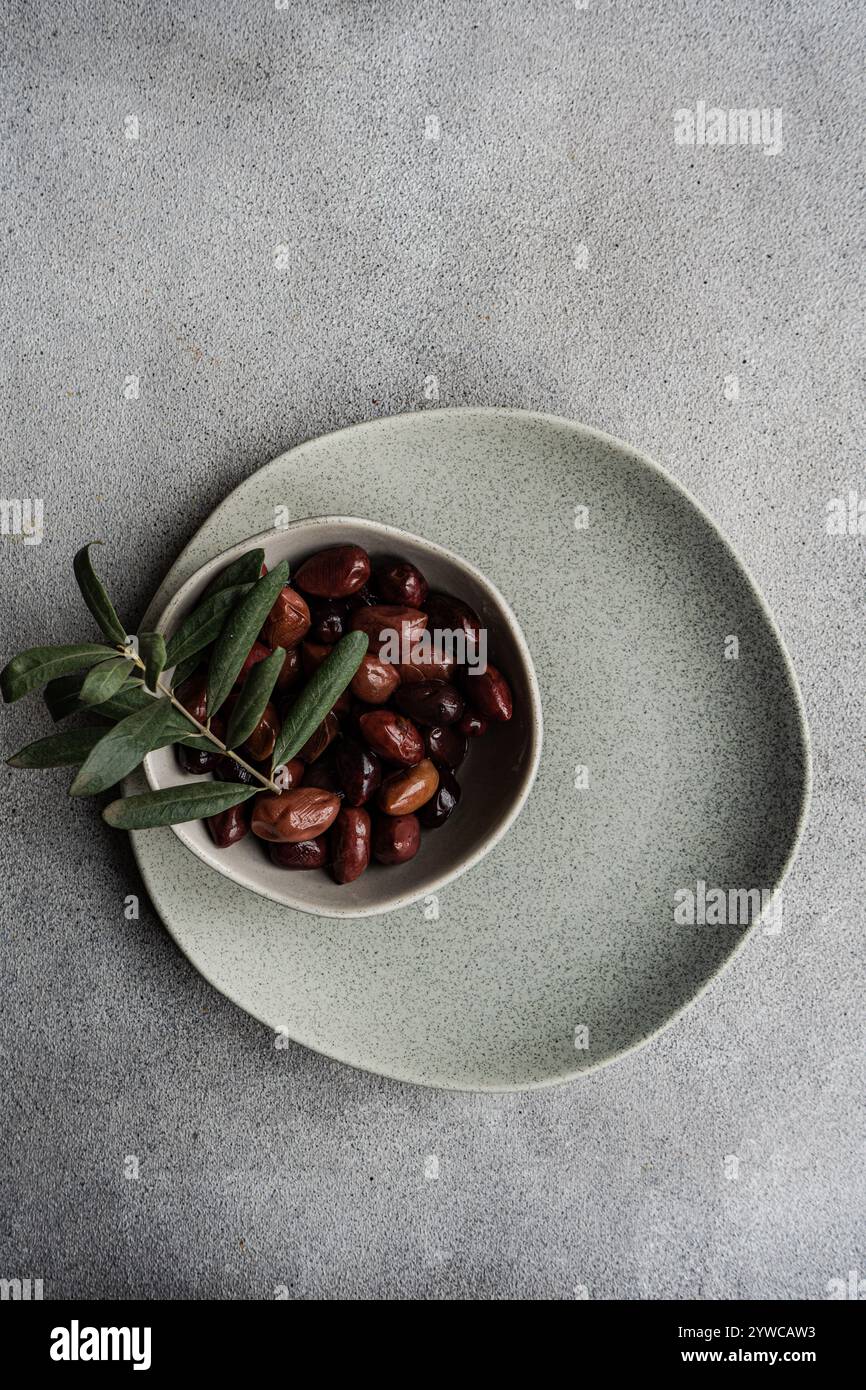 Overhead view of a bowl of black and brown marinated olives in a ...