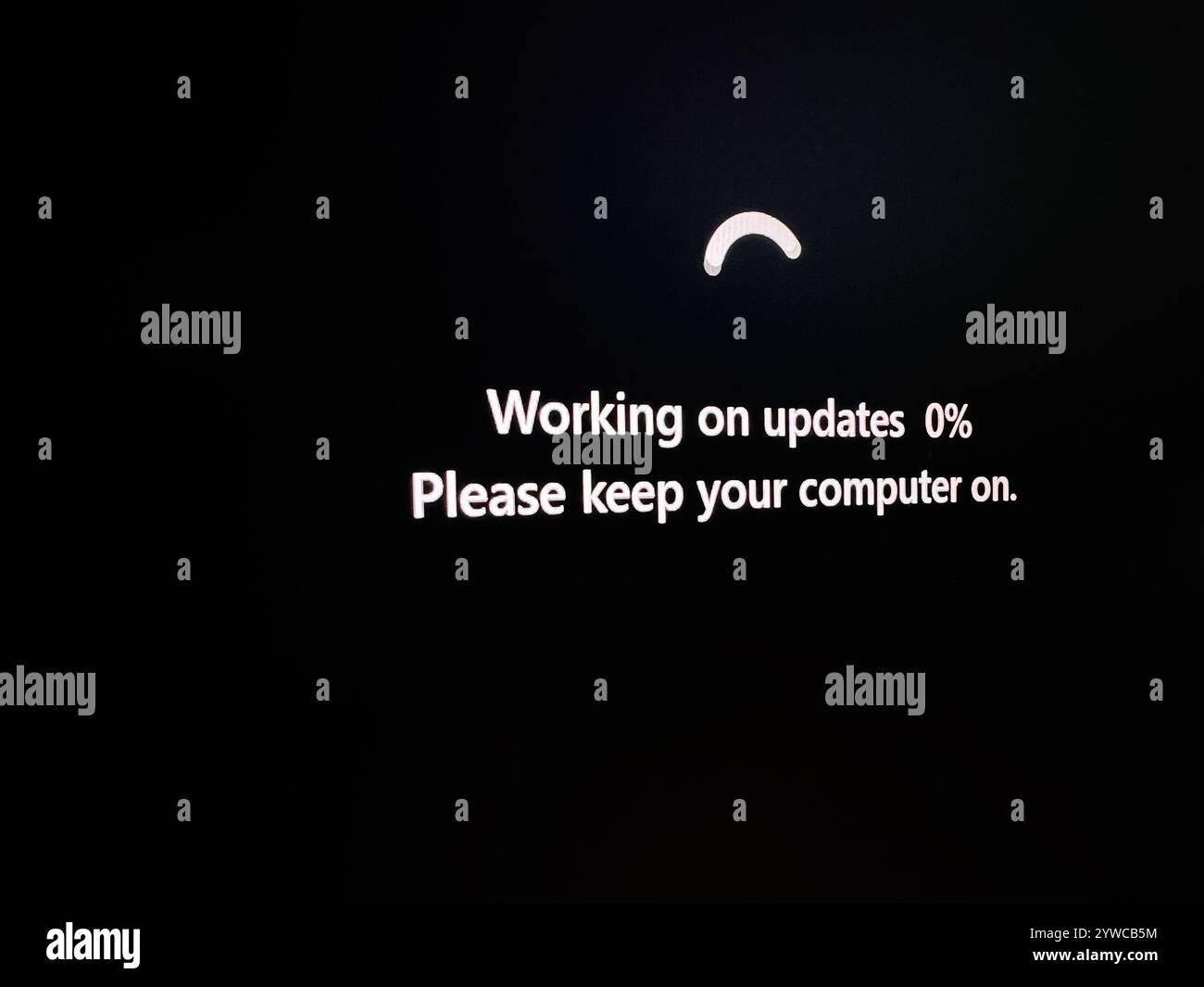 A computer screen displaying a software update progress message at zero ...