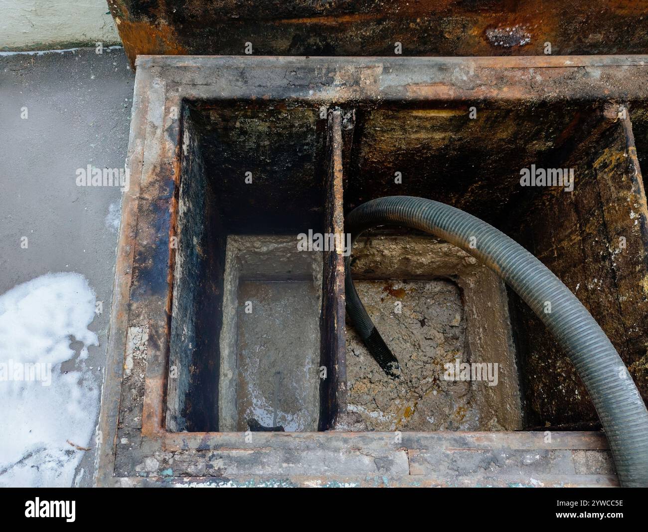 Waste pumping from the sewer. Mud and sludge removing by pumping hose ...