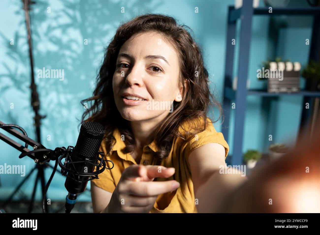 ASMR artist using quality mic and smartphone selfie camera in studio to ...