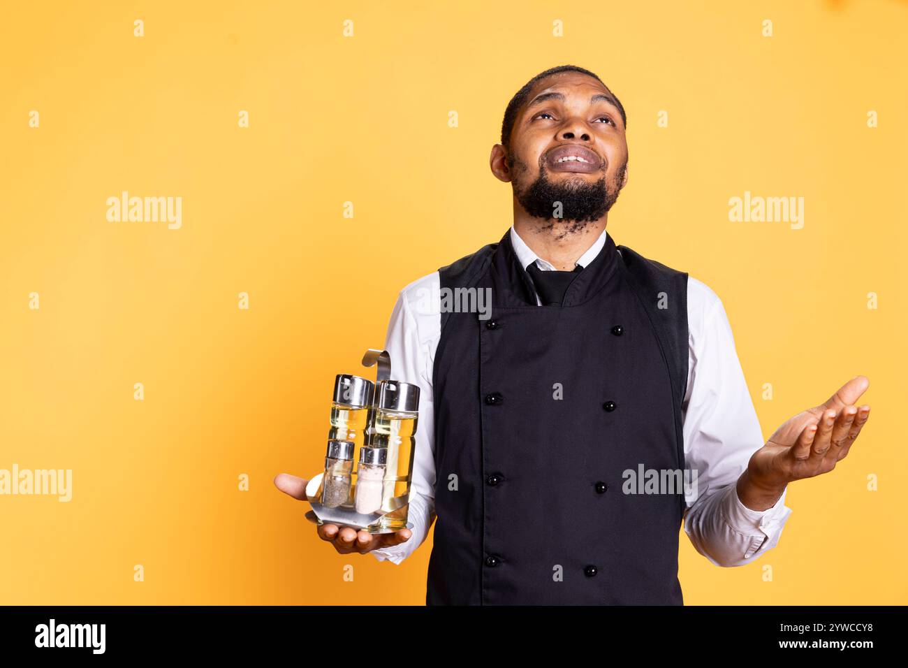Restaurant waiter praying to God before starting a new shift at work ...
