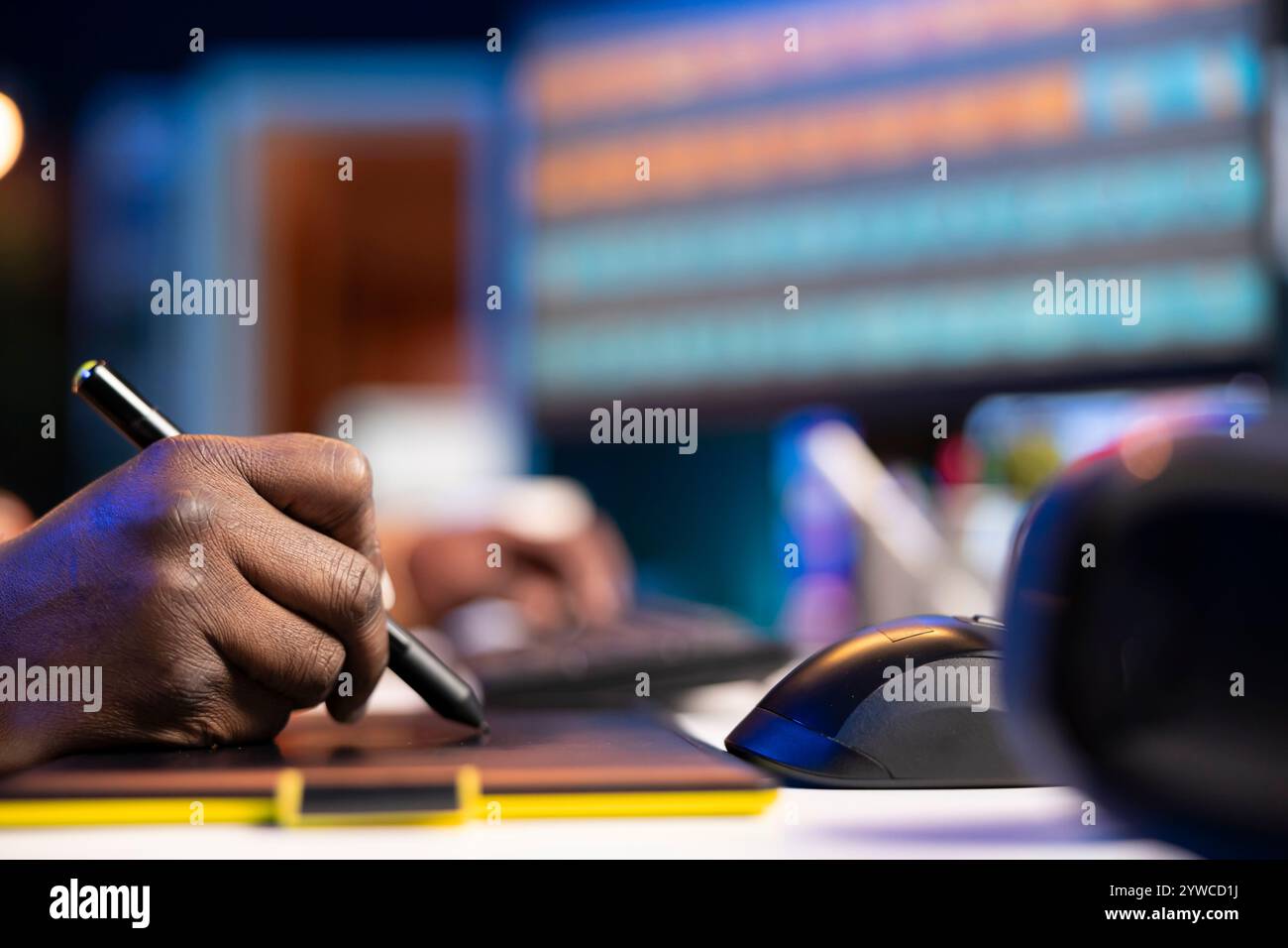 Black man photo editor in a well organized workspace editing images on ...