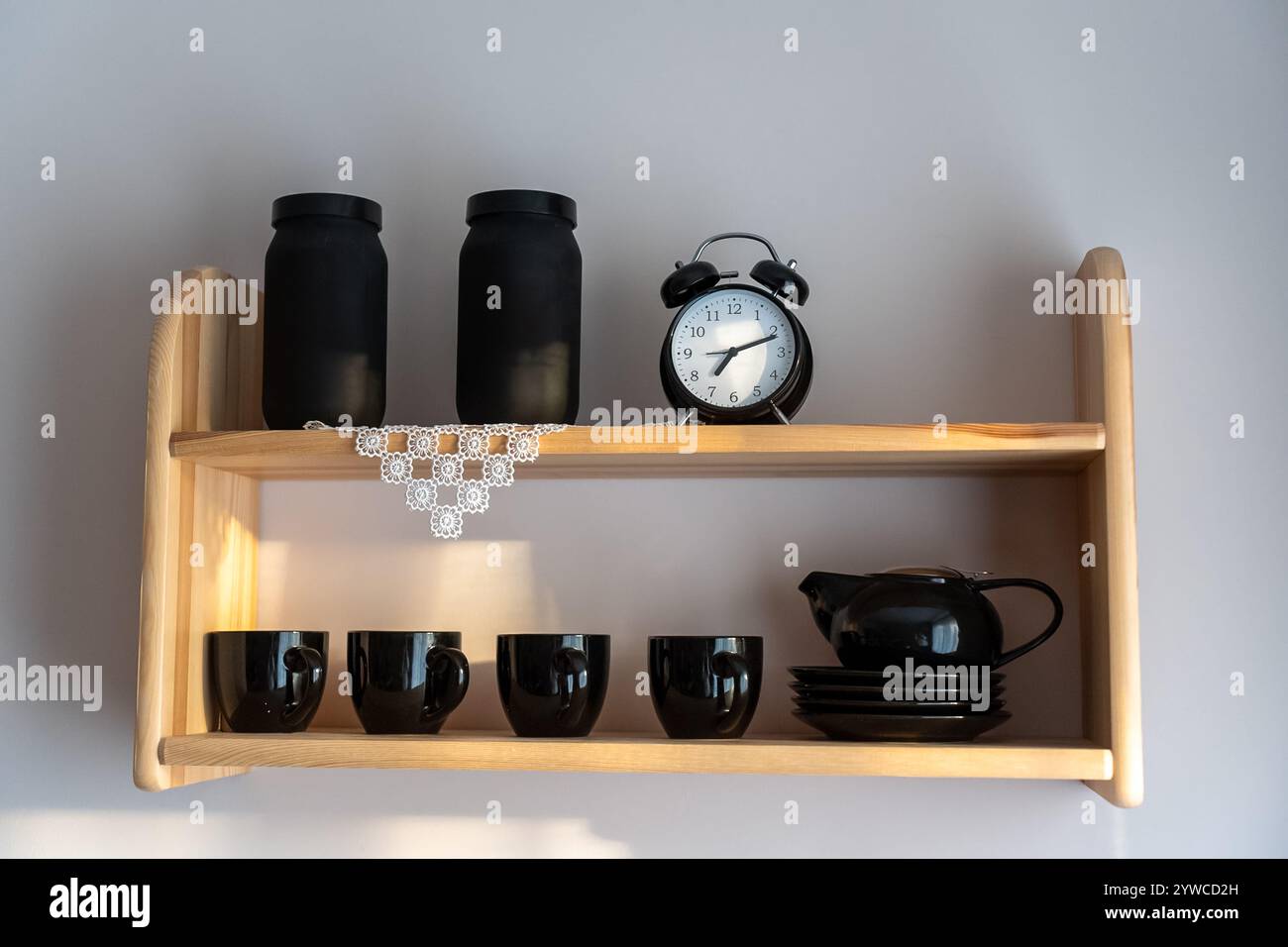 Wooden kitchen shelf with black ceramic dishes, jars, and a vintage ...