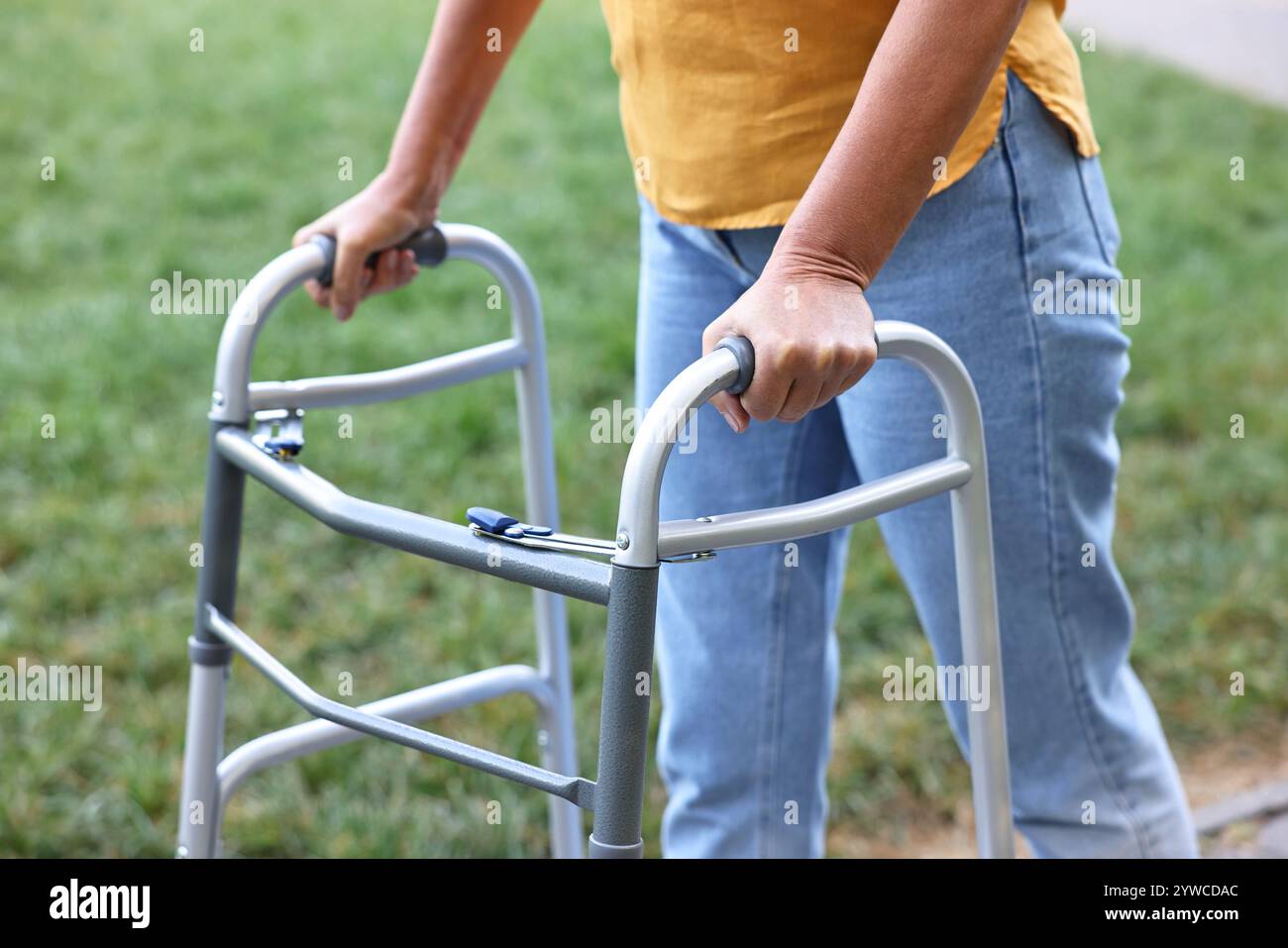 Senior woman with walking frame in park, closeup Stock Photo - Alamy