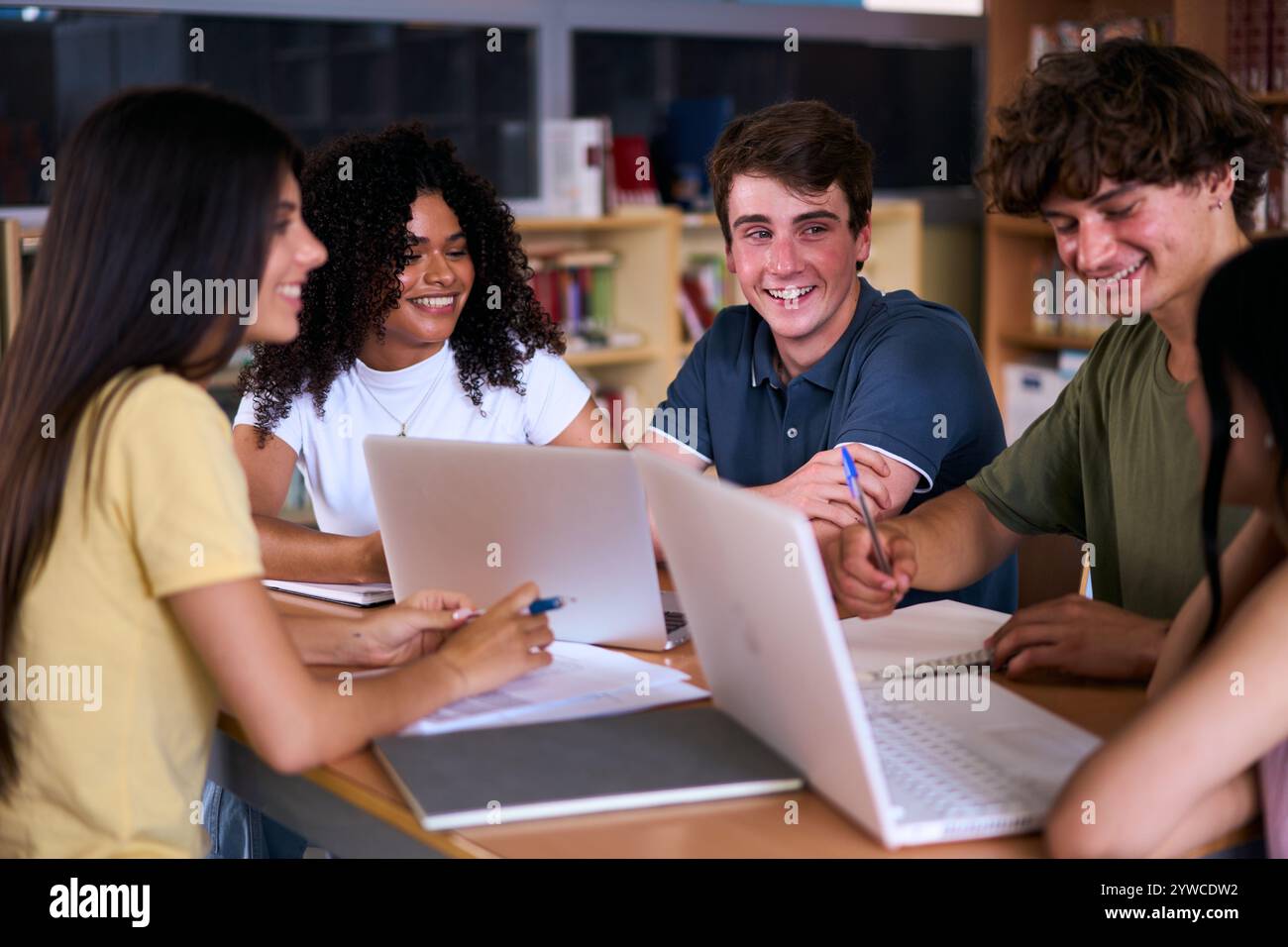 Group young high school students meeting doing classwork together using ...
