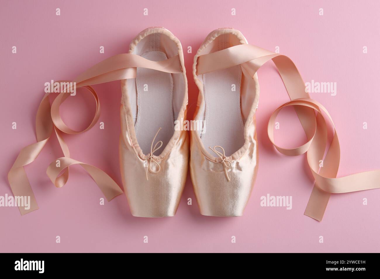Pair of beautiful pointe shoes on pink background, top view Stock Photo ...