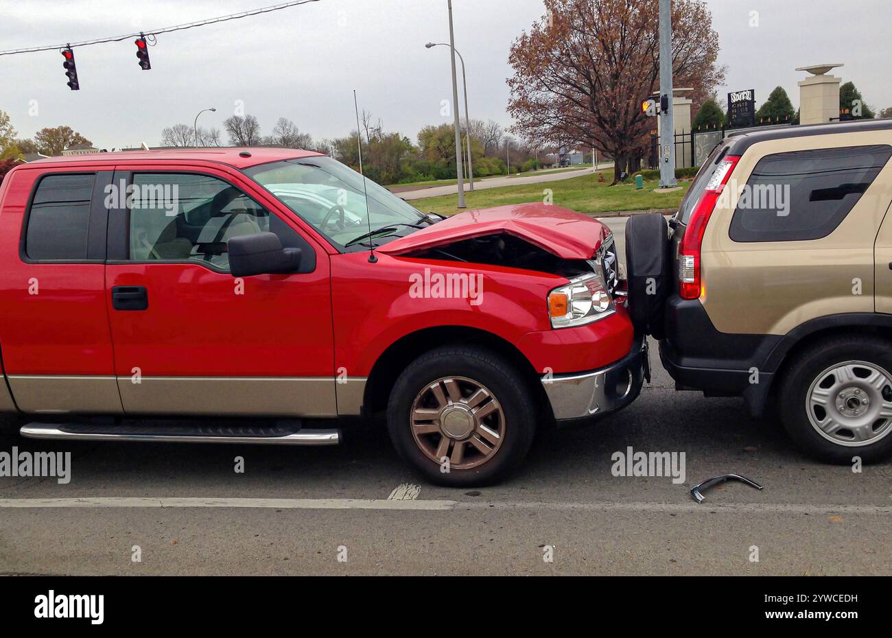 Red truck rear-end collision with brown SUV resulting in bent hood on ...
