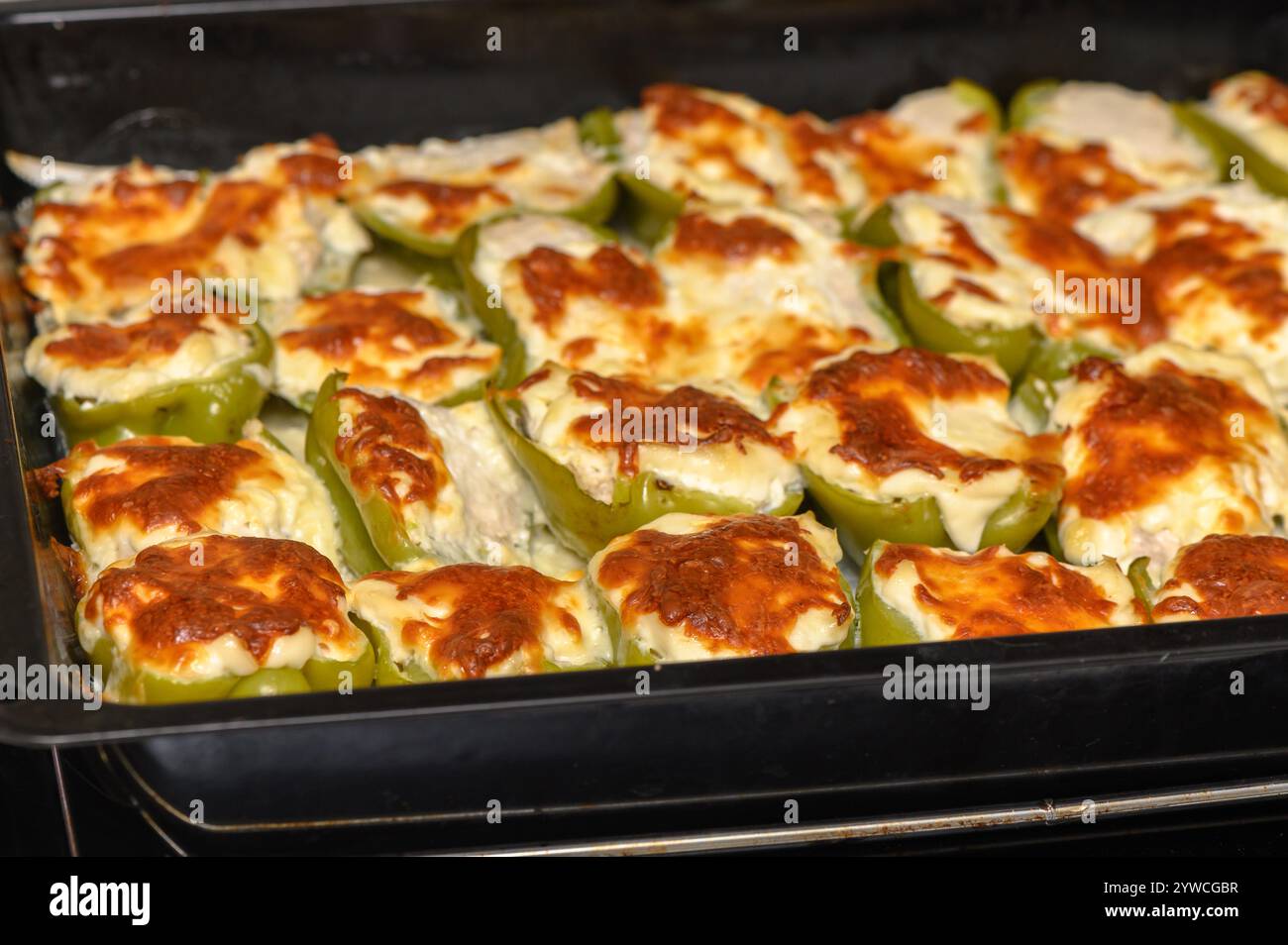 Mouthwatering stuffed peppers emerge from the oven, their cheesy tops ...