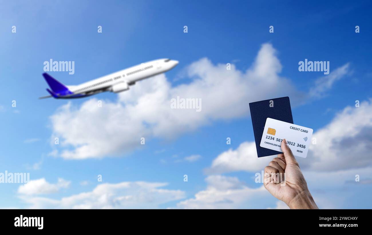 Human hand holding a passport and credit card with flying commercial ...