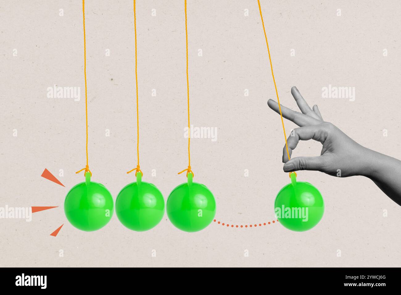 A human hand pulling a balancing ball on a pendulum on a colored ...