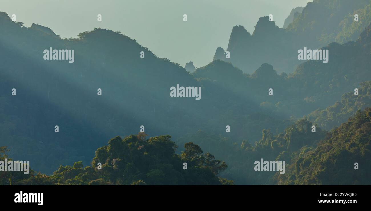 LaosLandscape of rainforest-covered mountains, crossed by sunbeams at ...