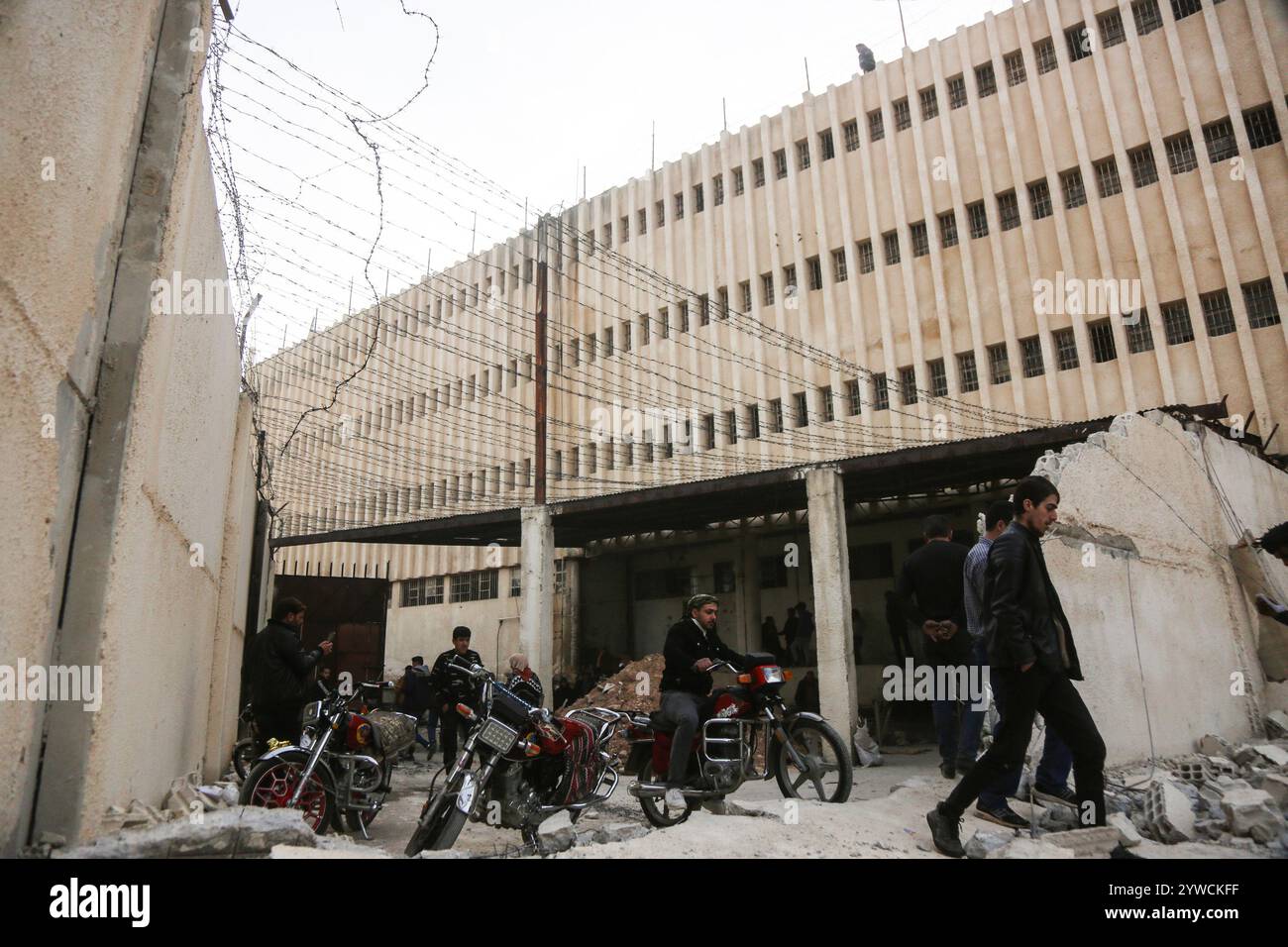 People gather at the Saydnaya prison in Damascus looking for loved ones ...