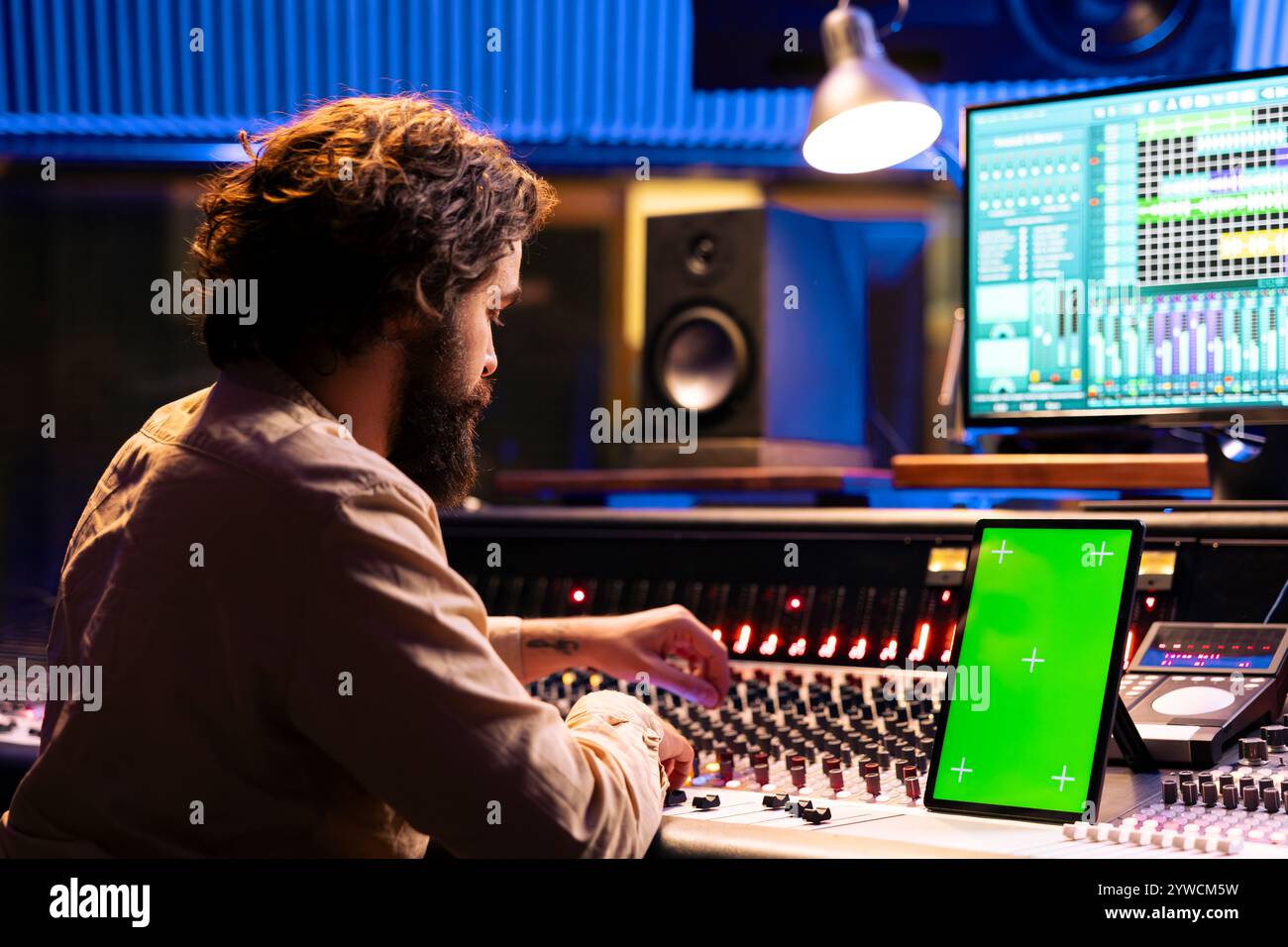 Sound engineer adjusting levels on hi-res stock photography and images ...