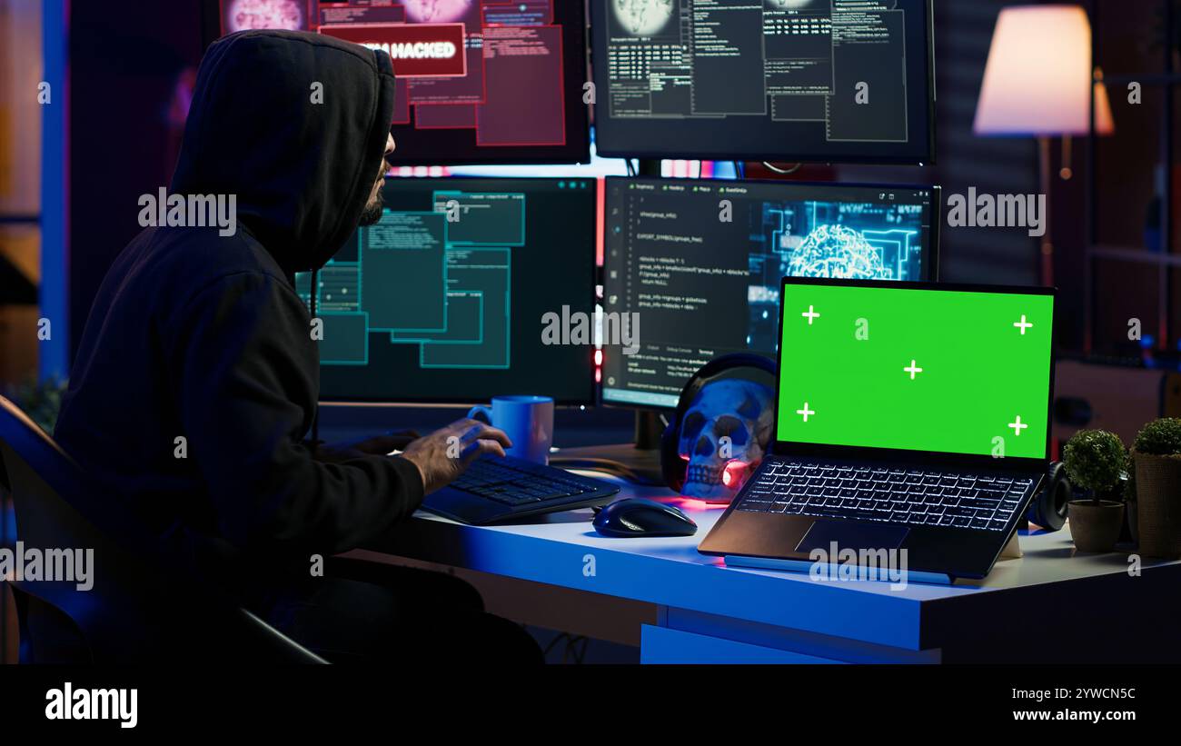 Green Screen Laptop Used By Hacker In Underground Hideout To Write Lines Of Code Developing