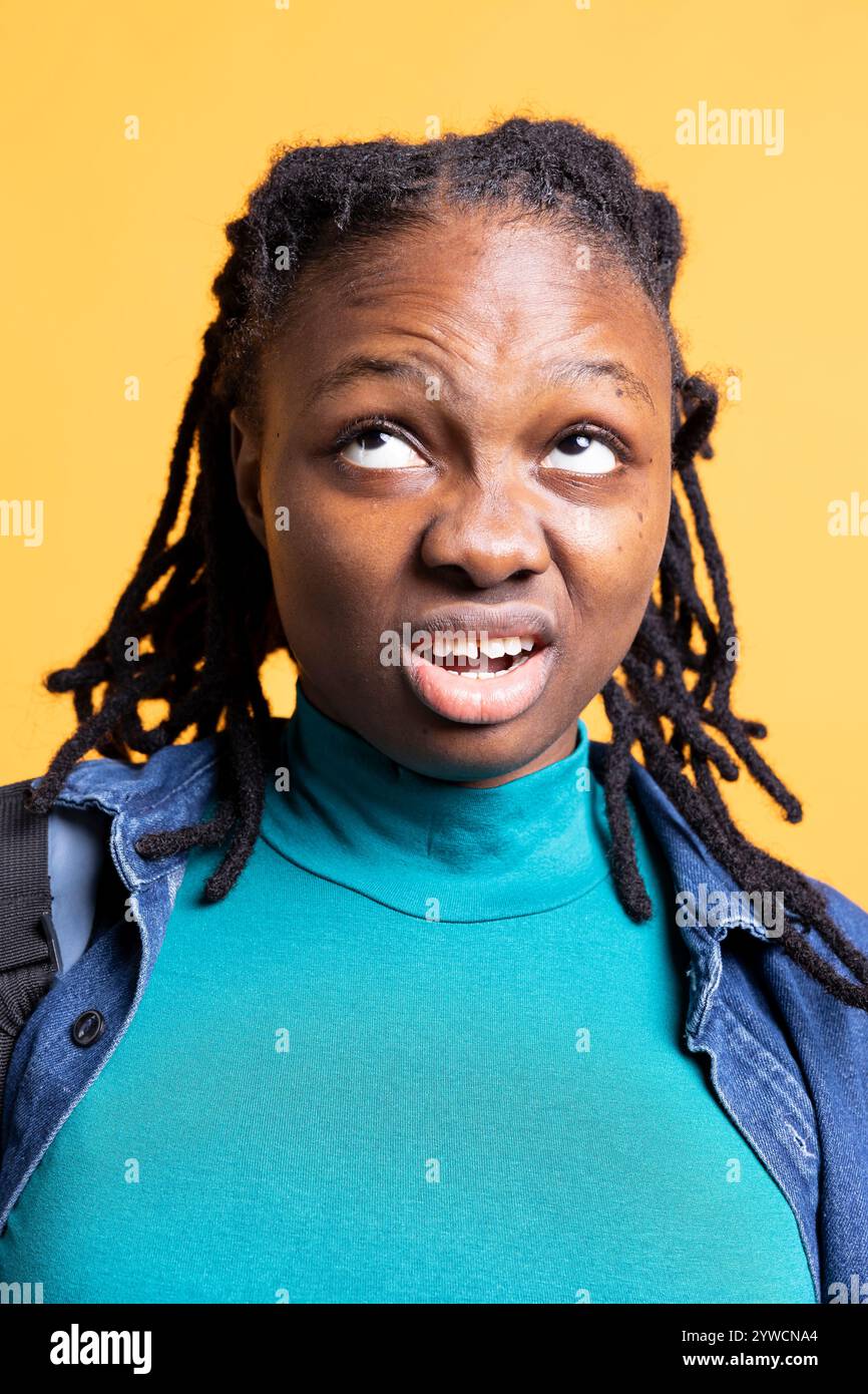 Portrait of wacky teenager rolling eyes, acting zany, isolated over ...