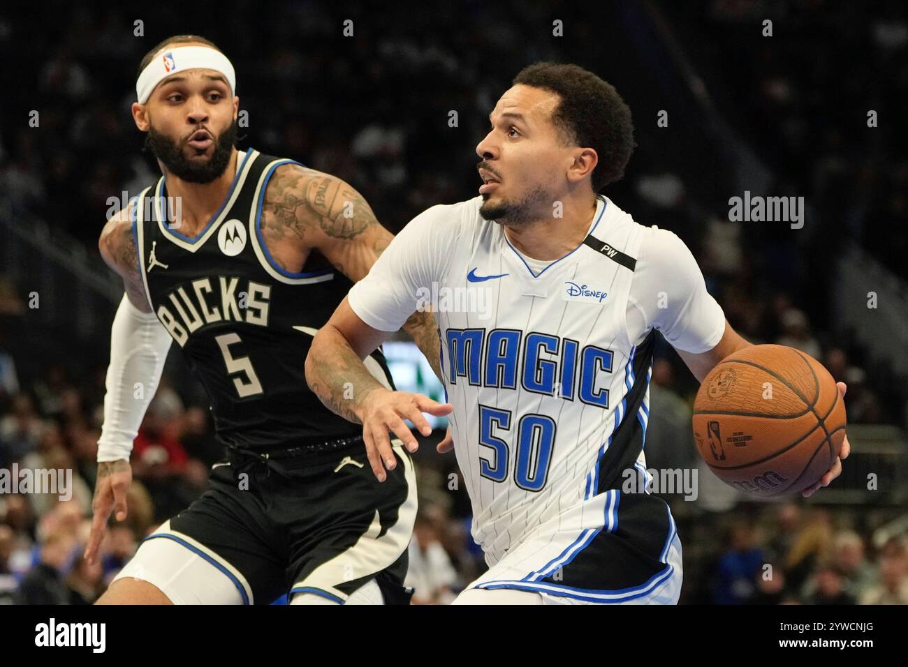 Orlando Magic's Cole Anthony drives by Milwaukee Bucks' Gary Trent Jr ...
