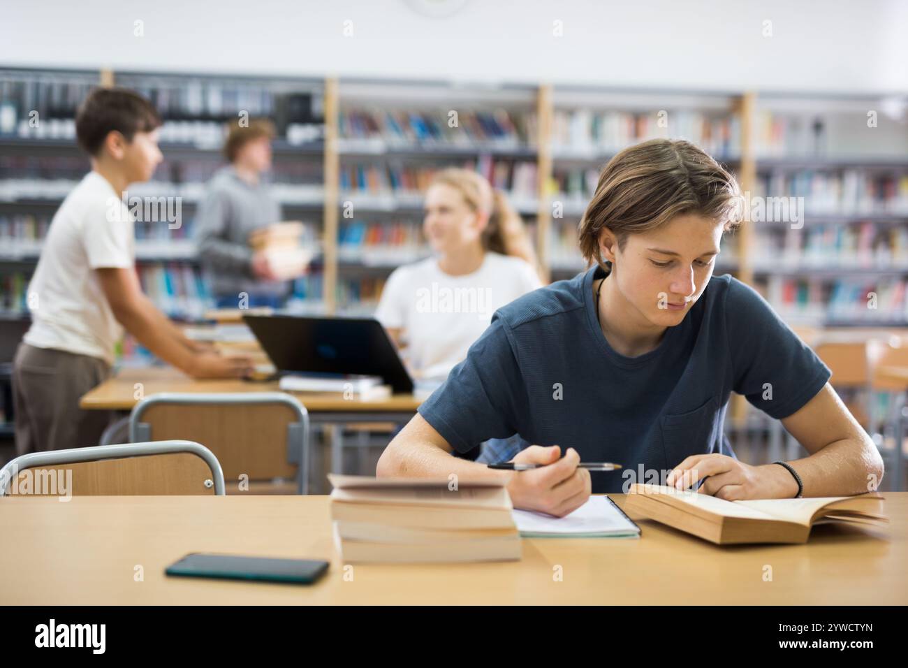 Fifteen-year-old schoolboy writes an synopsis Stock Photo - Alamy