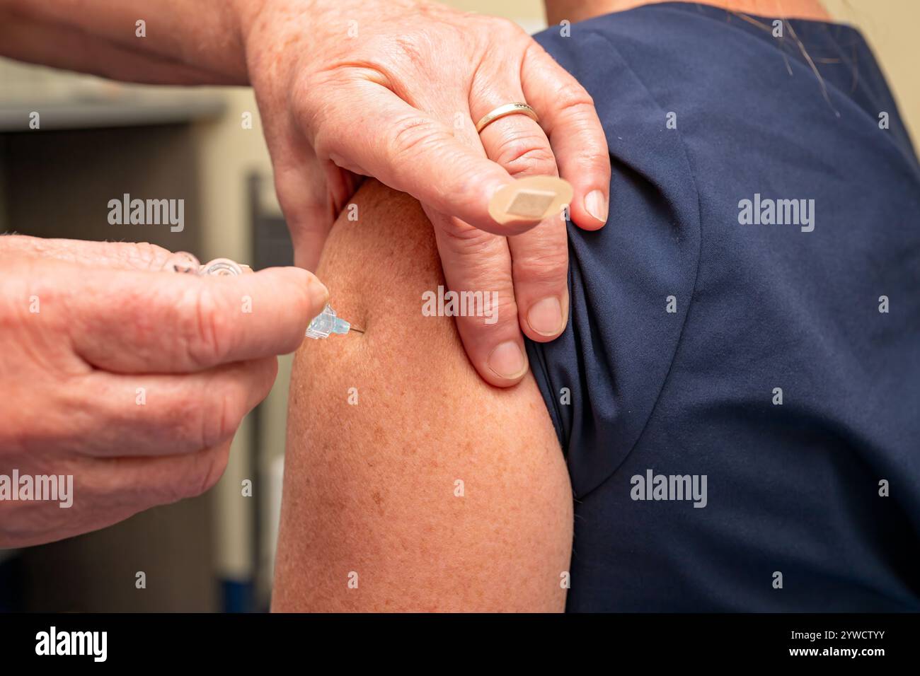 woman receiving vaccination injection from nurse, needle immunisation ...