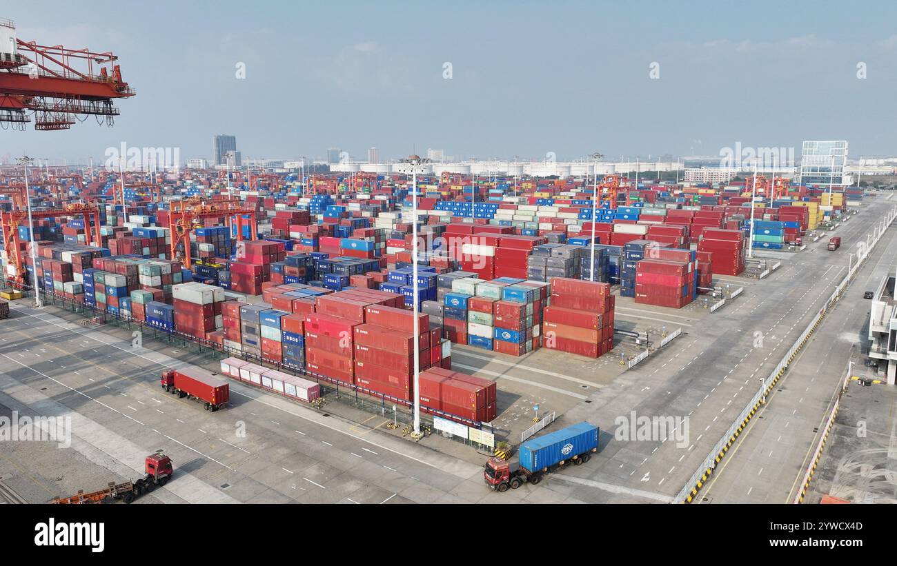 The trucks are transporting containers into the port at Qinzhou ...