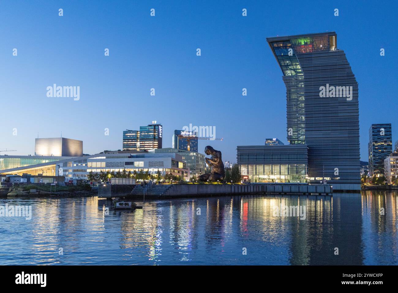 Oslo Opera House and Munch museum in Oslo illuminated in the evening ...