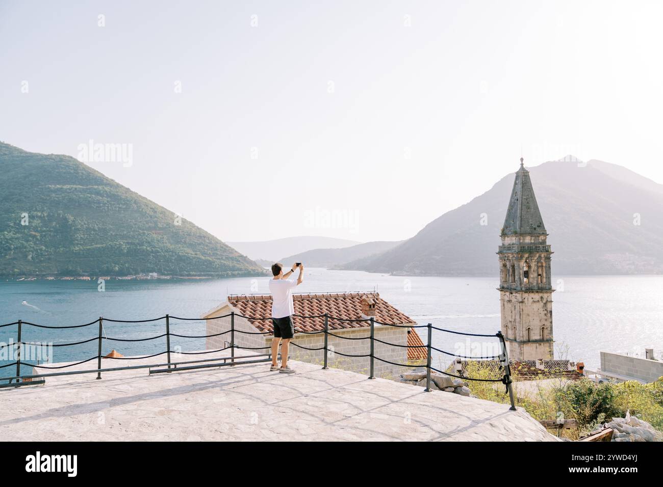 Man on the observation deck takes pictures of the old bell tower ...