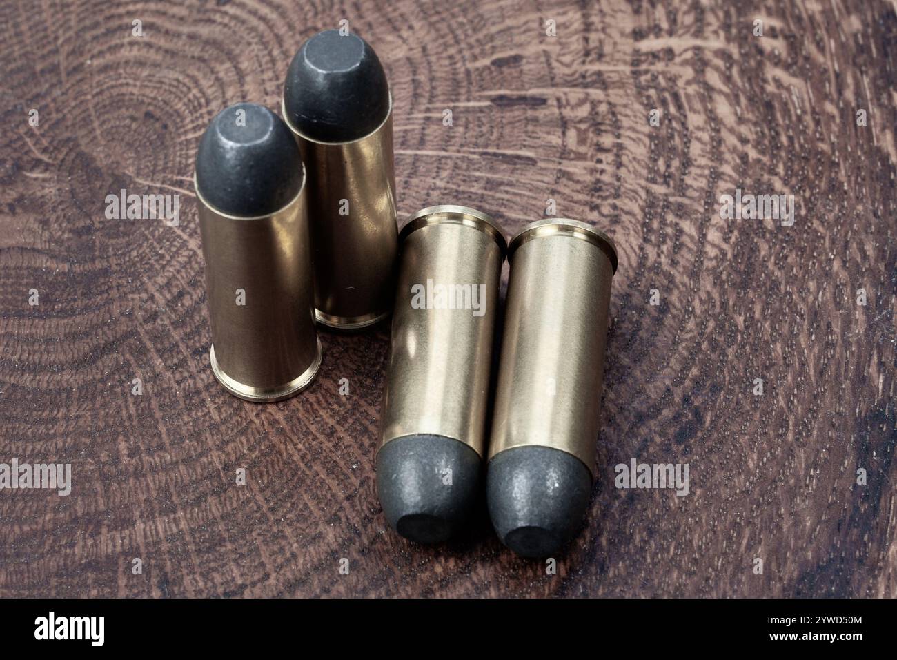 Old West era Long Colt .45 caliber revolver cartridges on a wooden ...
