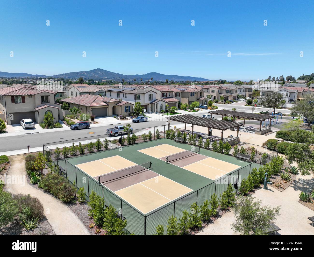 Aerial view of a pickle ball complex with courts beside a playground in ...