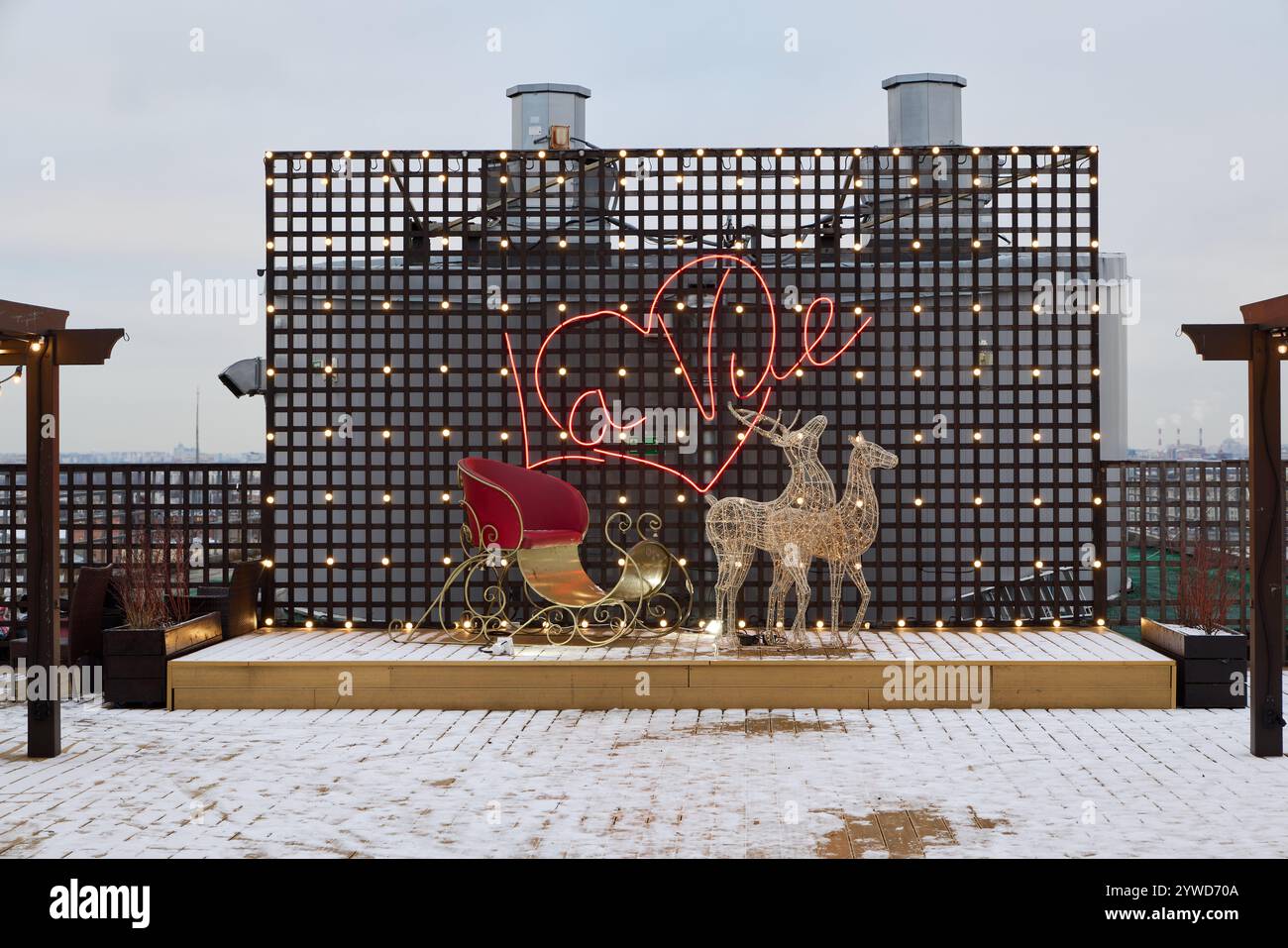 A beautifully festive winter rooftop scene adorned with a charming ...