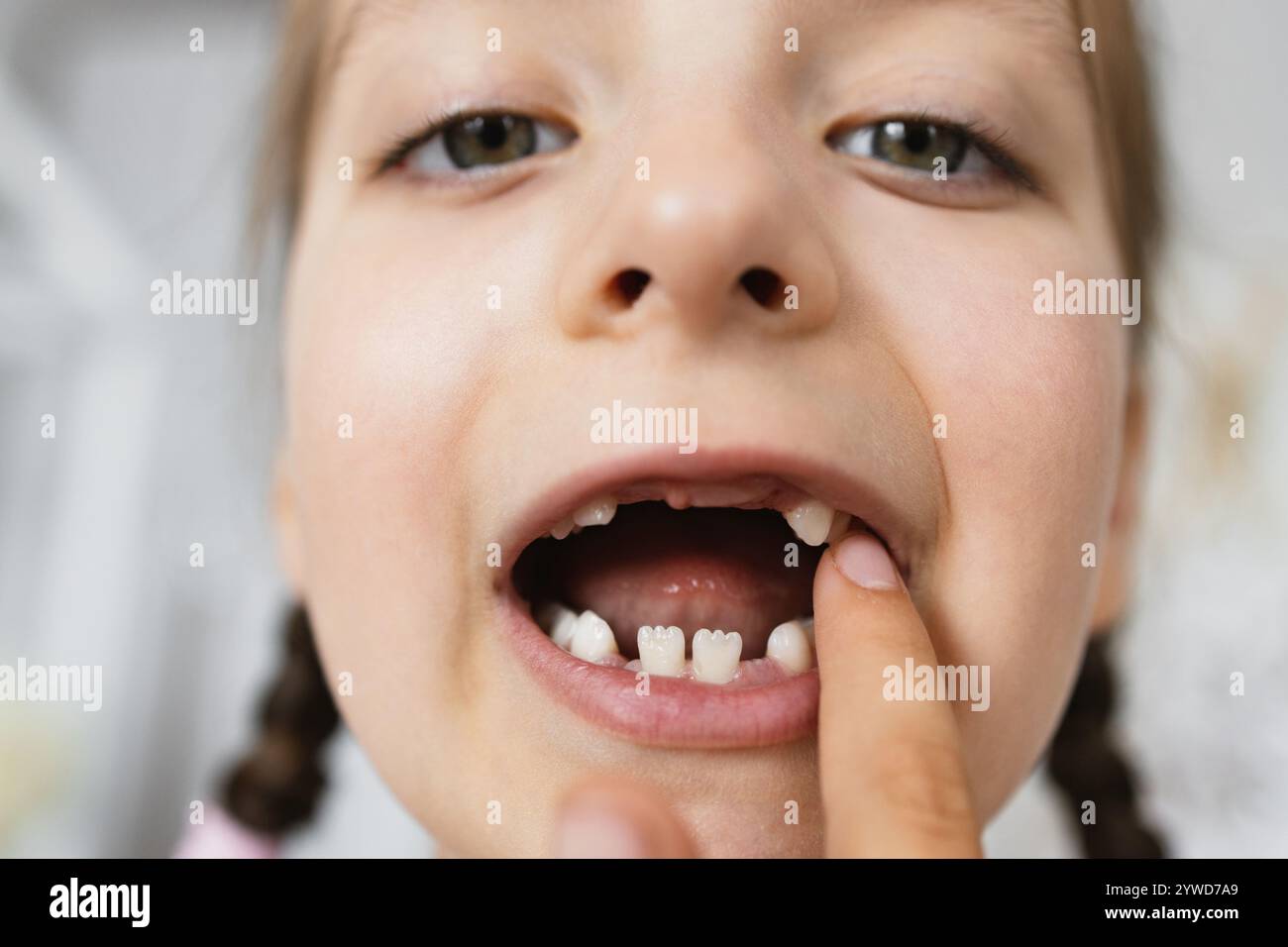 Close-up portrait of Caucasian girl with braided hair showing her ...