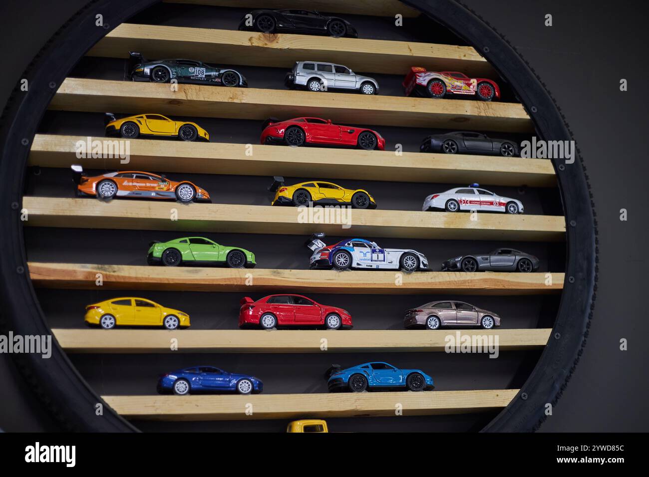 Toy cars collection on a display shelf in several rows. miniature ...