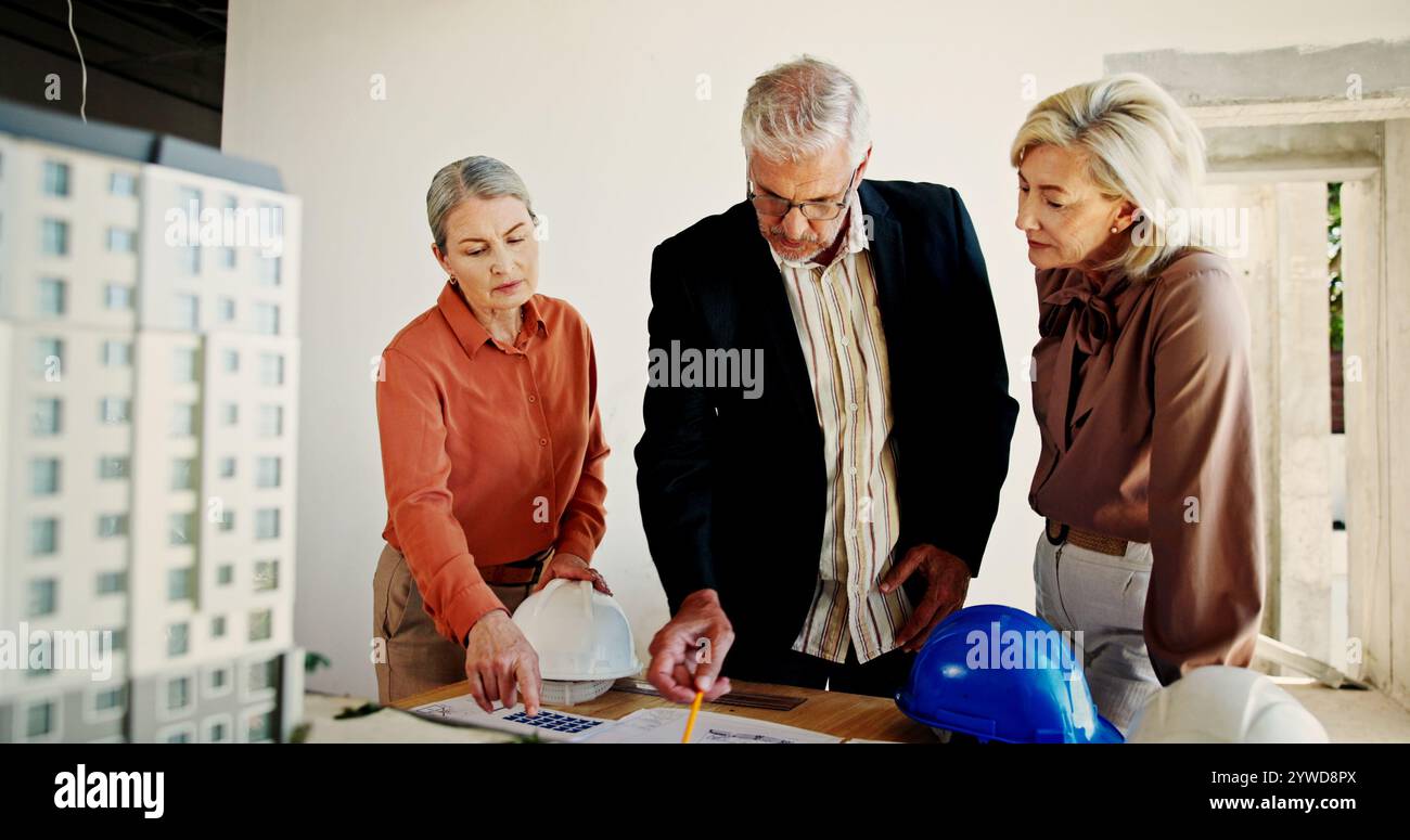 Mature architect, team and discussion with blueprint for construction ...