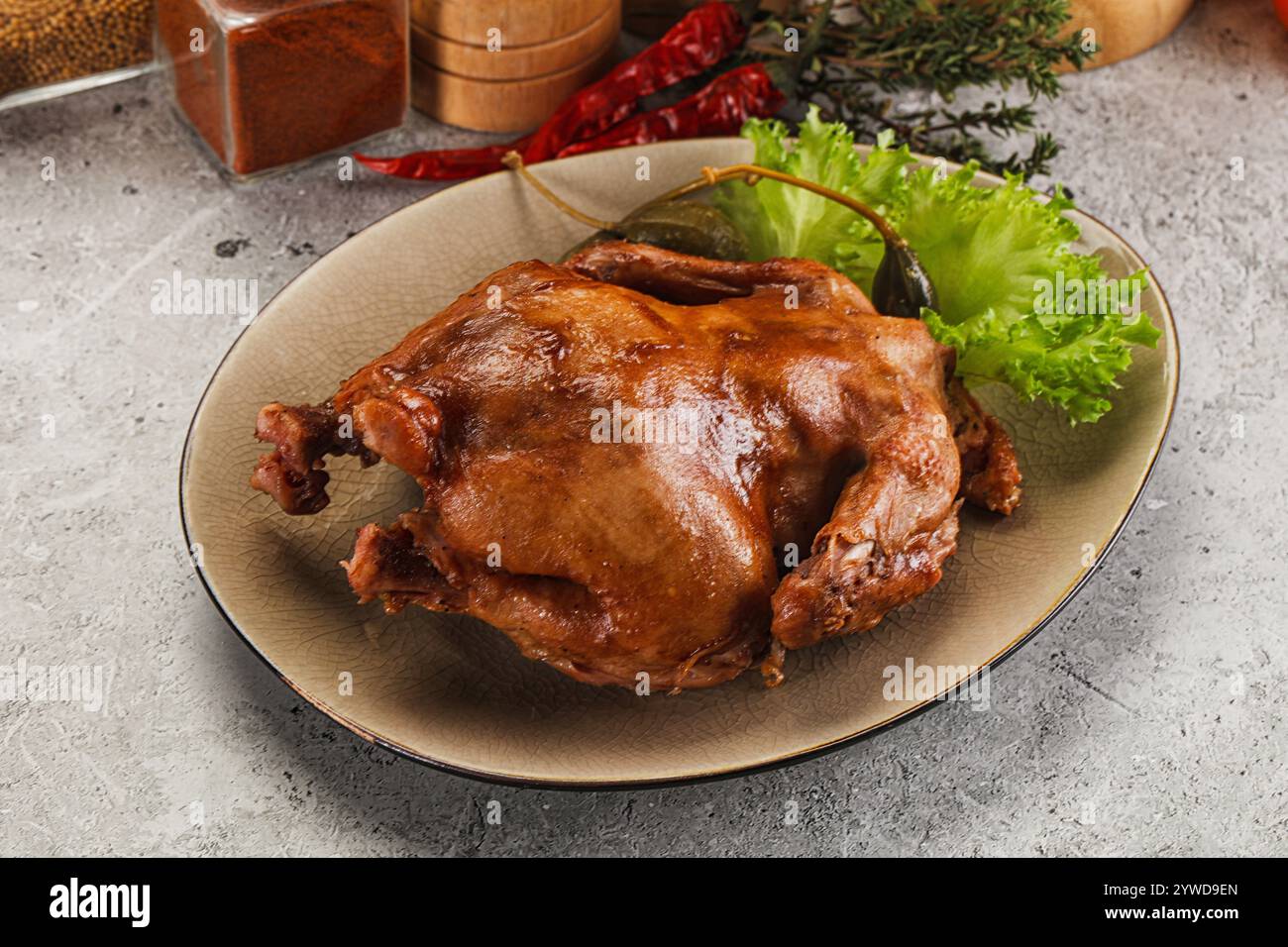 Baked whole small chicken with spices Stock Photo - Alamy