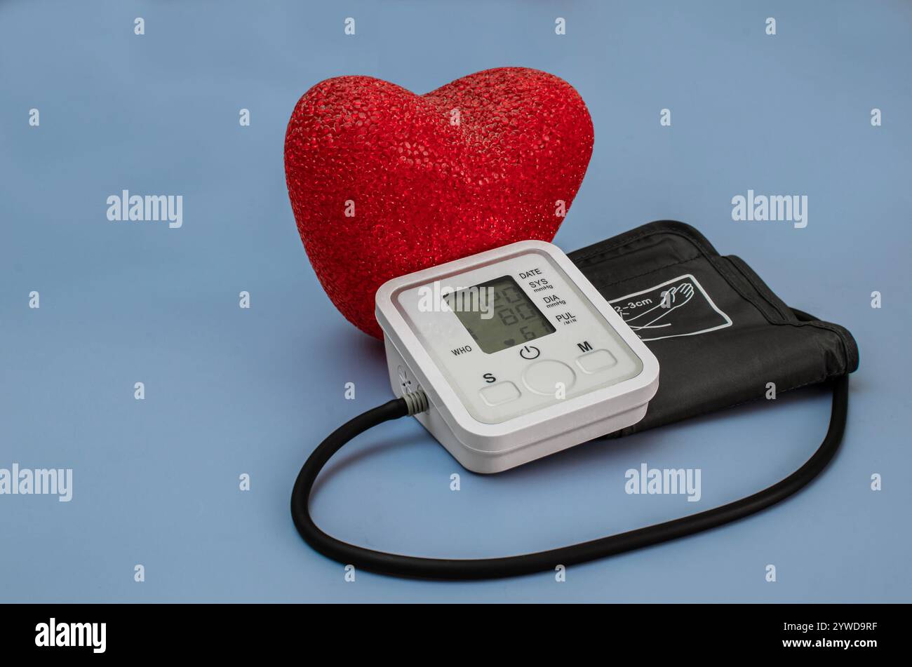 White electric tonometer on a blue background with heart. Pressure ...