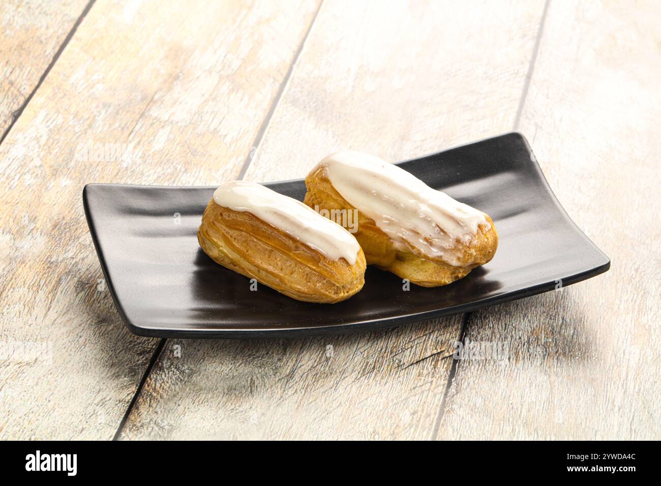 Delicous tasty eclair with ising and cream Stock Photo - Alamy