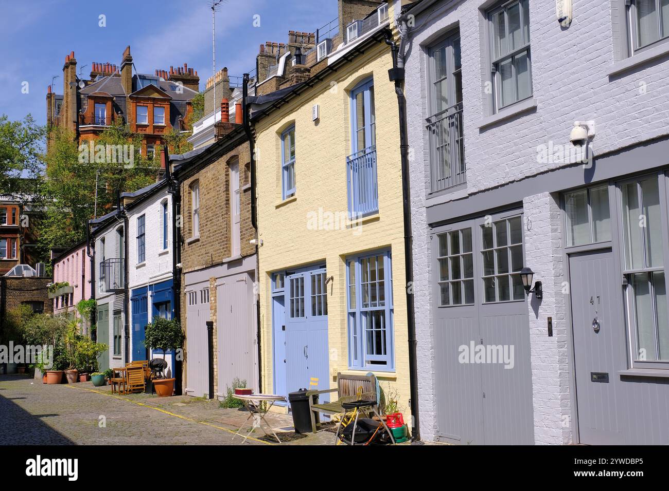 Pastel colour terrace cottages in Cranley Mews, South Kensington ...