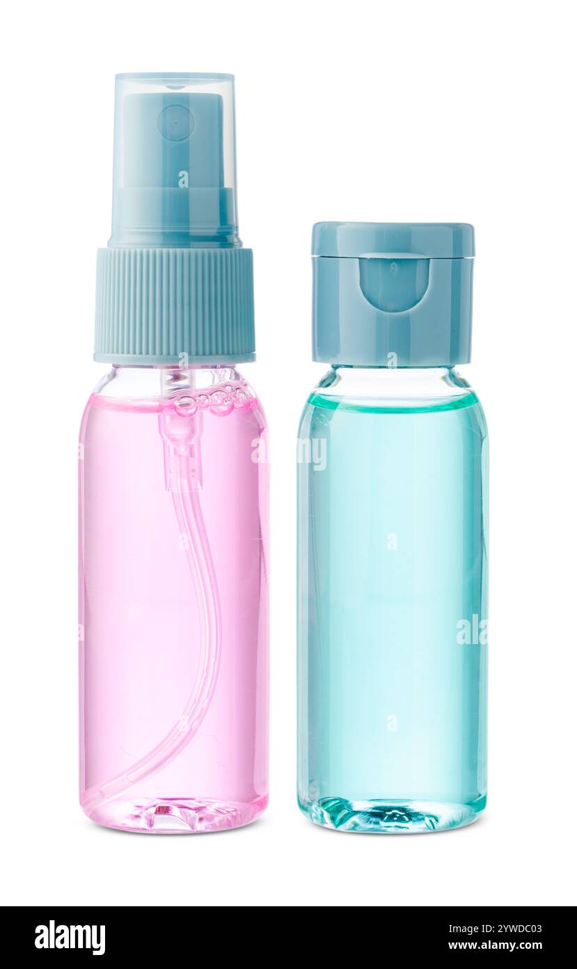 Various bottles with colored liquids and pumps arranged on white ...