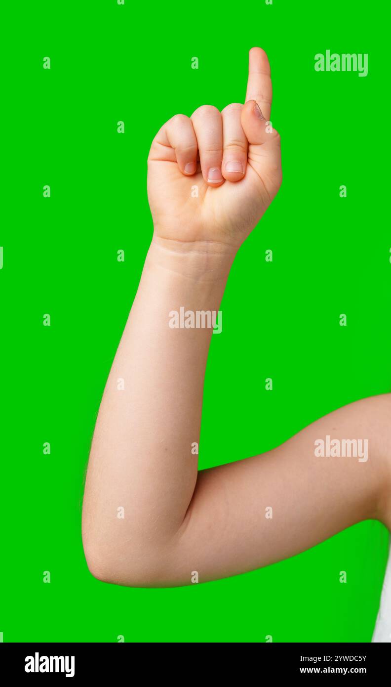 A hand raised with an index finger pointing upwards against a bright ...