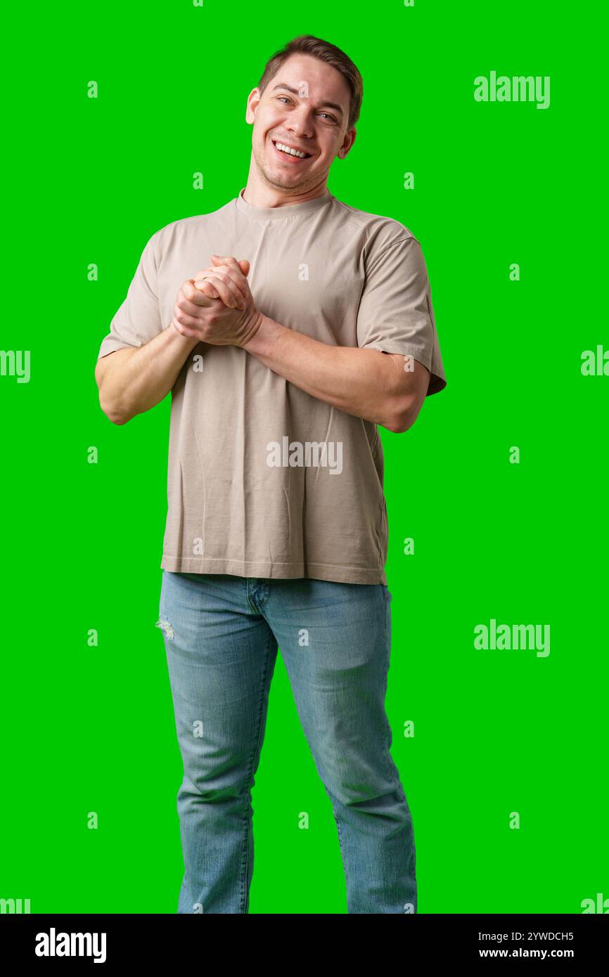 A cheerful man with a friendly smile poses against a bright green ...