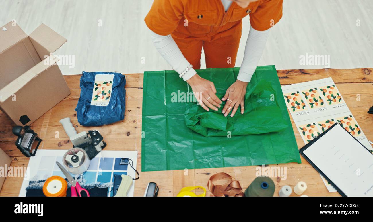 Small business, hands and packaging clothes for shipping with online ...