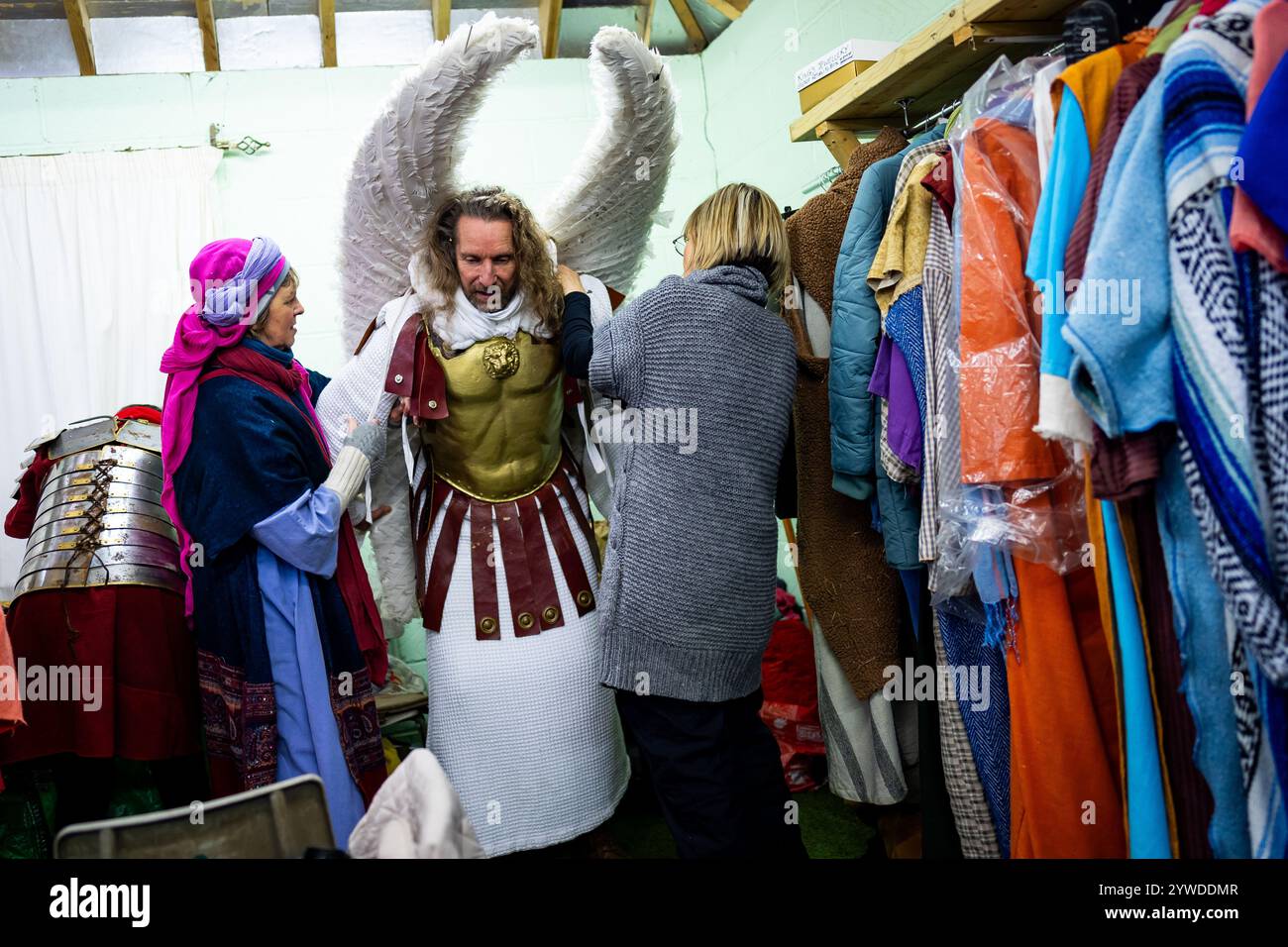 An actor playing Archangel Gabriel is helped into costume at the dress ...