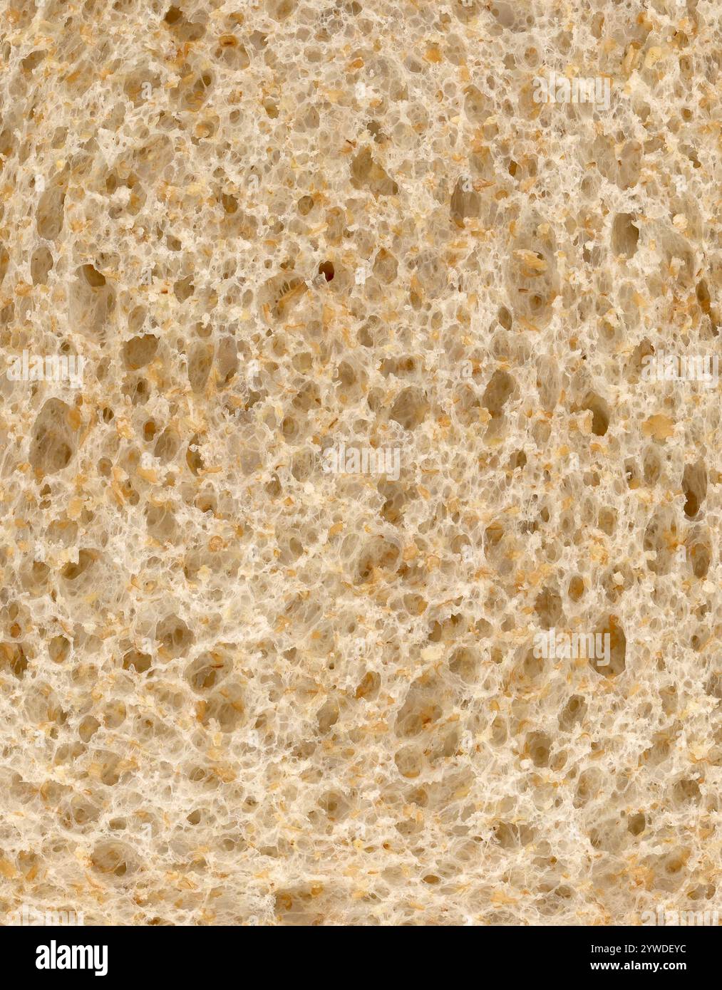 Slice of high fibre brown wholemeal bread close up texture detail ...